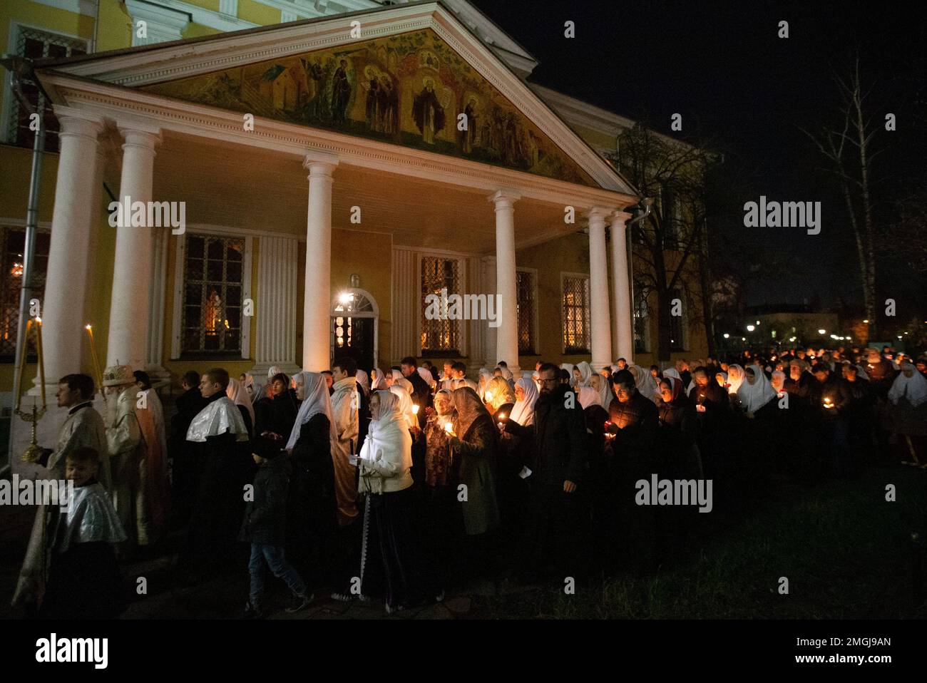 Worshipers with candles attend a religion procession celebrating ...