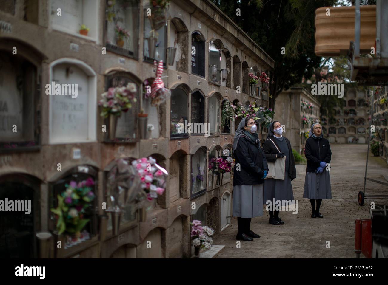 Three nuns stand next to the coffin of Inmaculada Louzan, a sister of ...