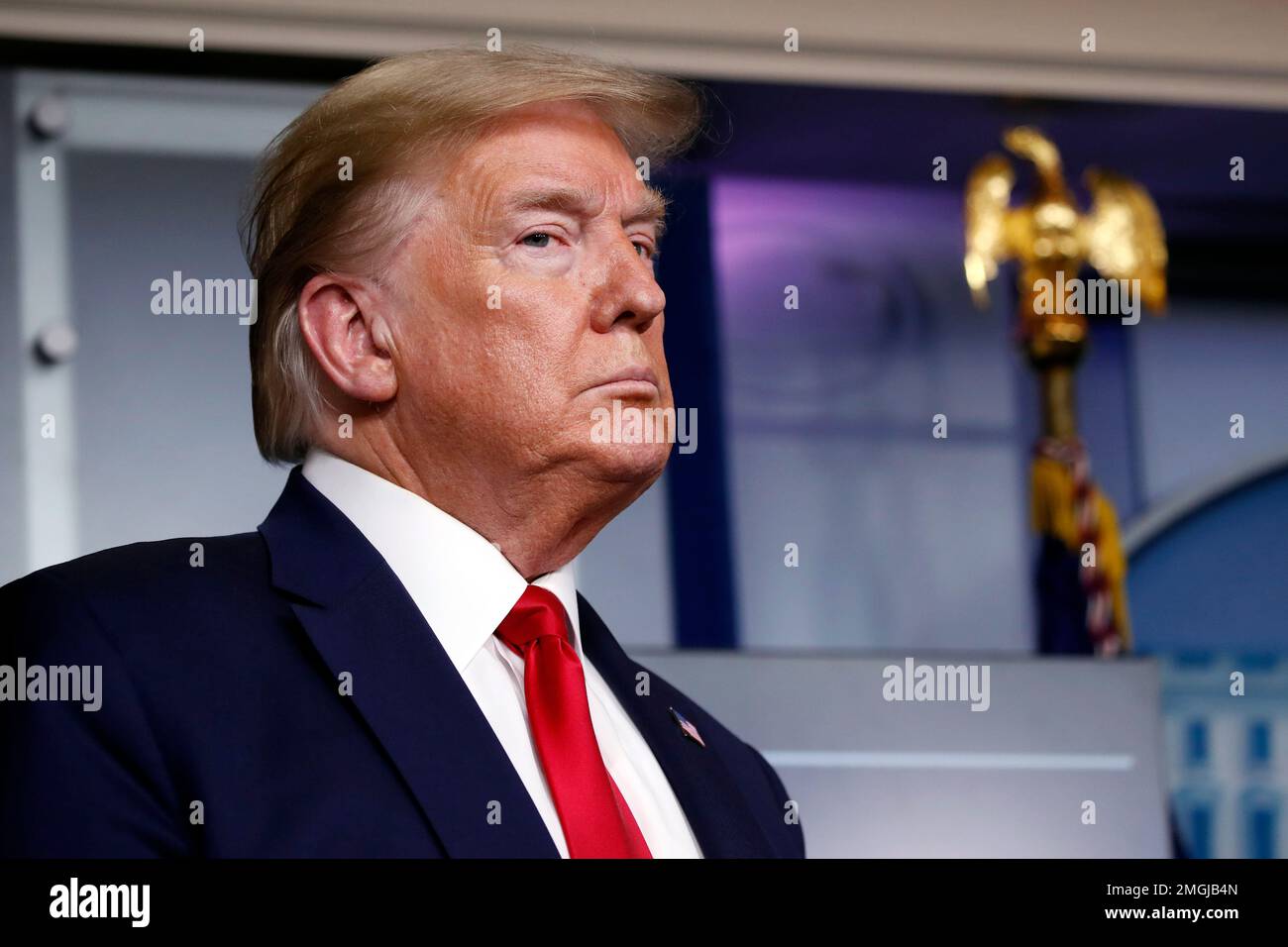 President Donald Trump listens as Agriculture Secretary Sonny Perdue ...