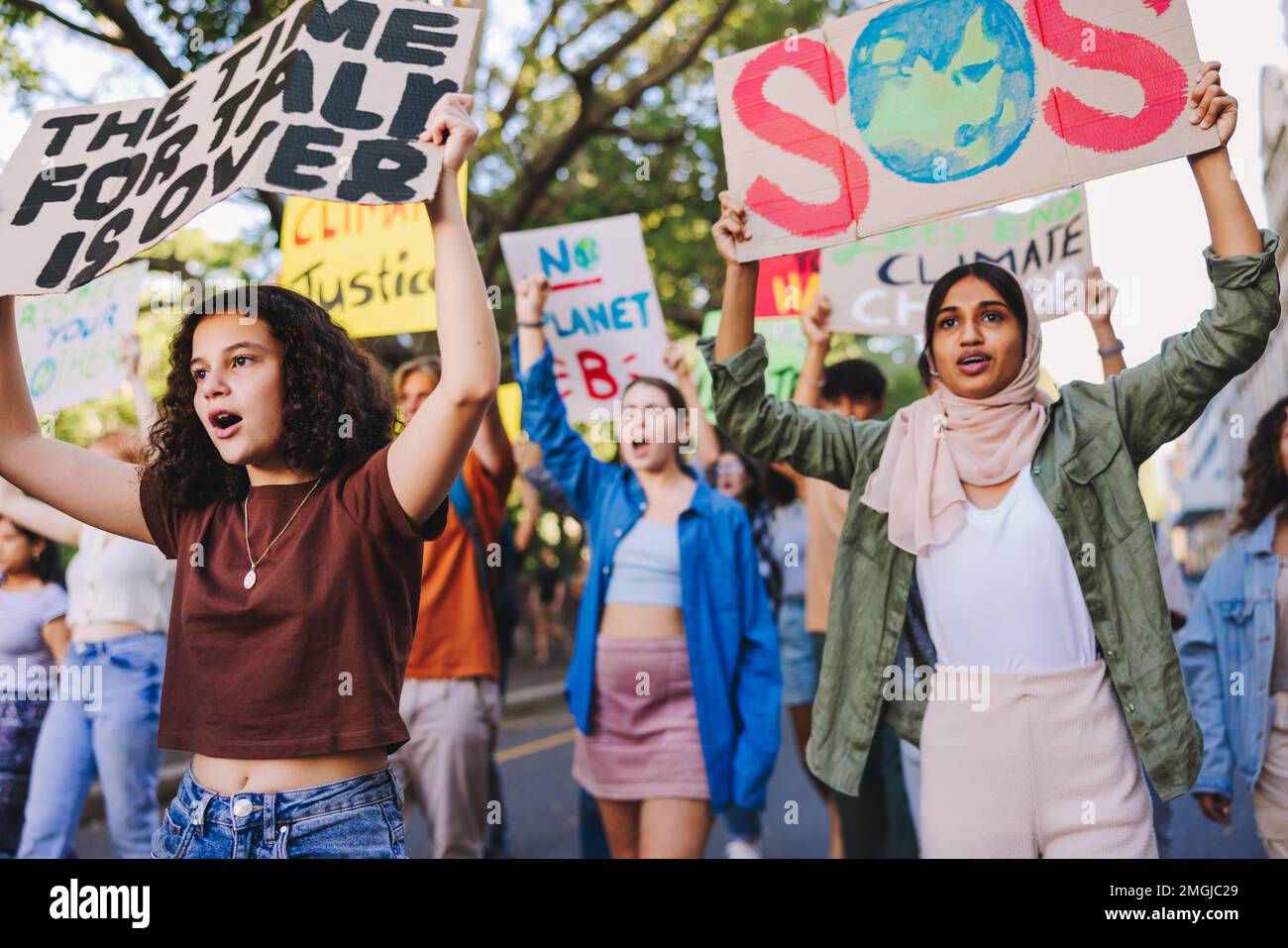 Group of youth activists standing up against climate change and global warming. Multicultural ...