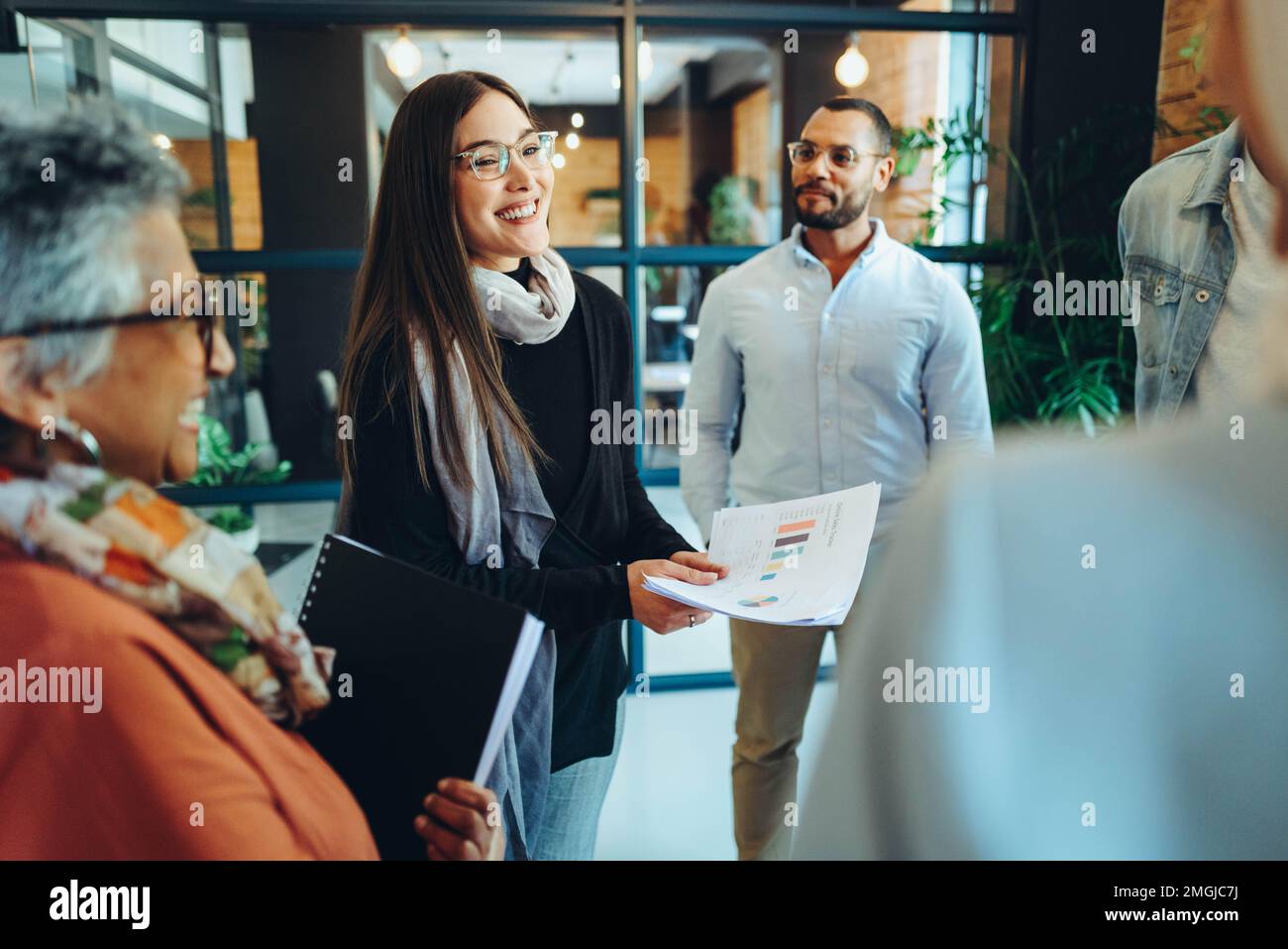 Cheerful businesspeople holding a staff meeting in a modern office ...