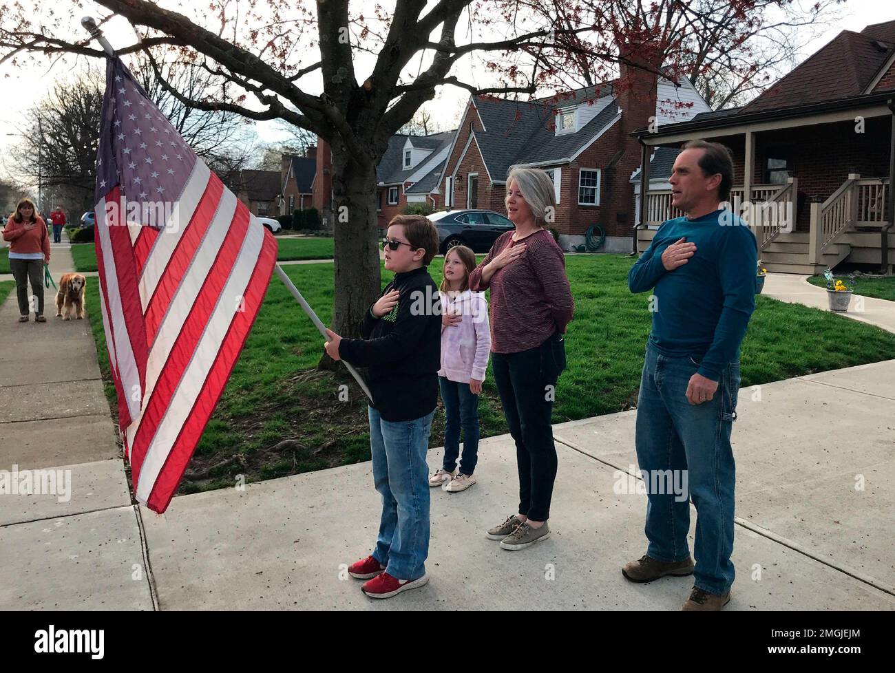In this photo taken April 7, 2020, Zach Stamper holds the U.S. flag ...