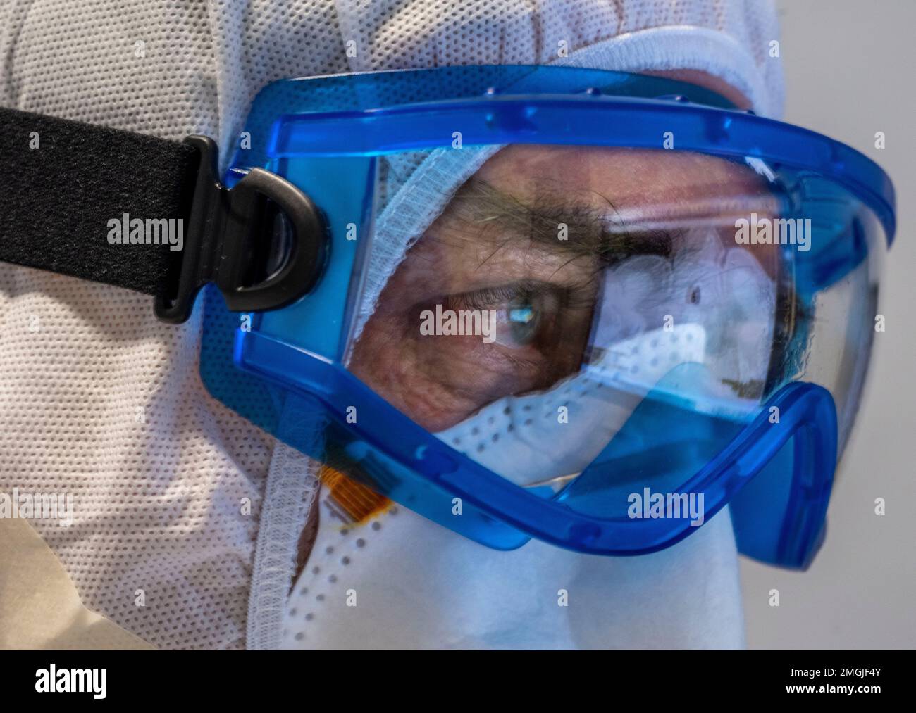 Doctor Giovanni Passeri, wearing protective gear, looks at lungs CT ...