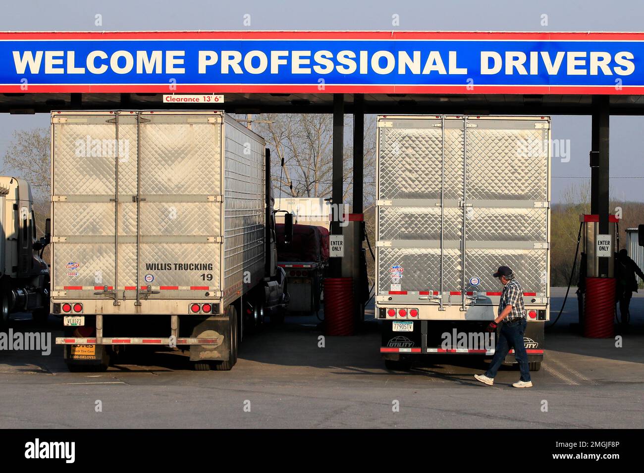 A trucker checks his rig while filling up at BETO Junction, a truck ...