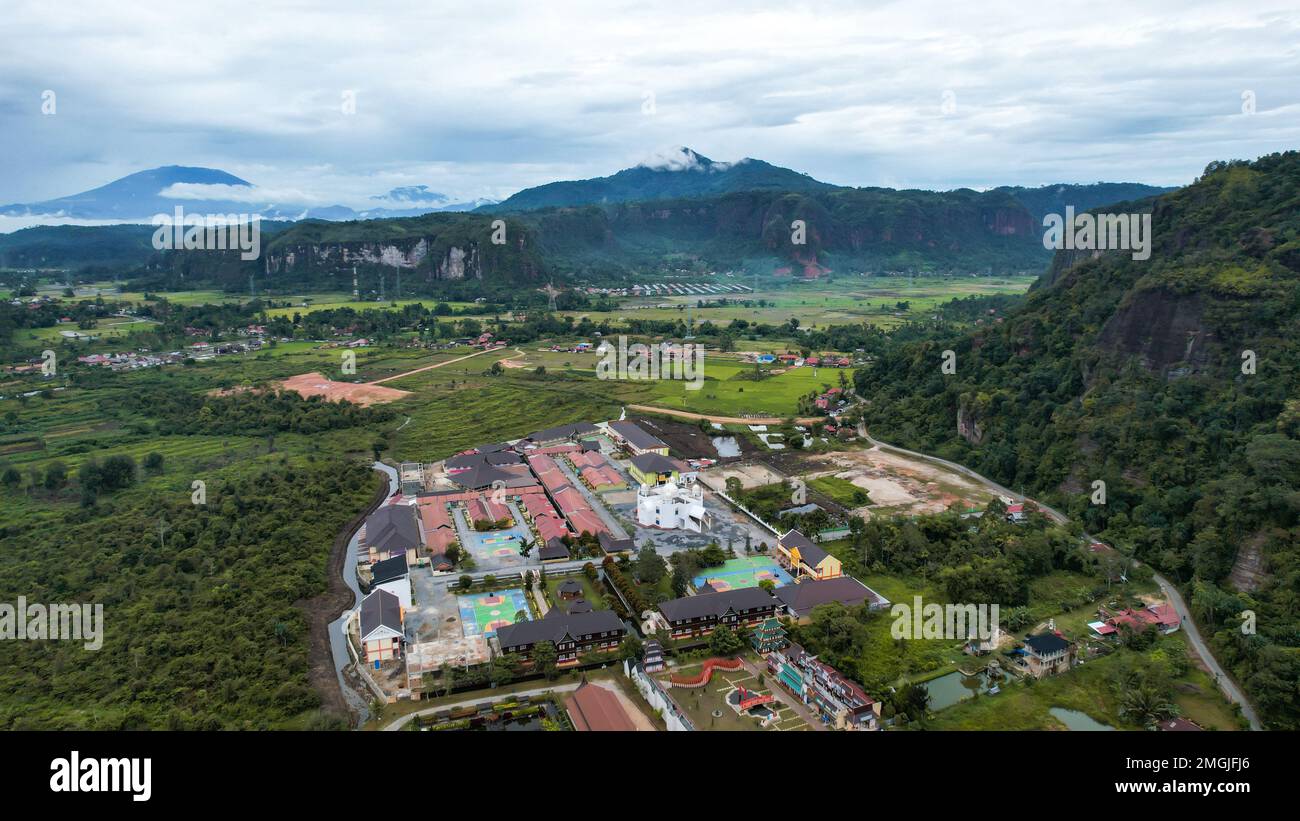 Aerial view of white mosque in a beautiful landscape view of Harau ...