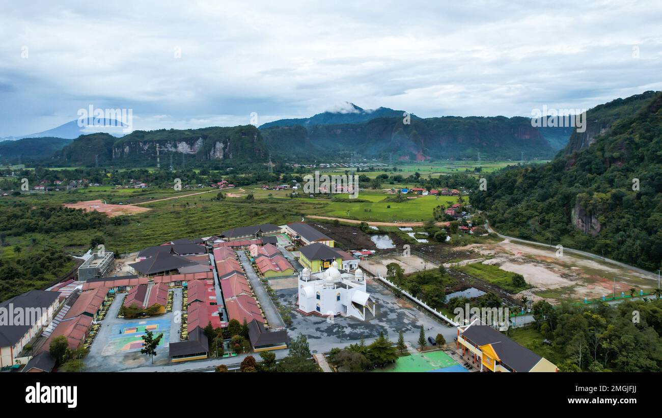 Aerial view of white mosque in a beautiful landscape view of Harau ...