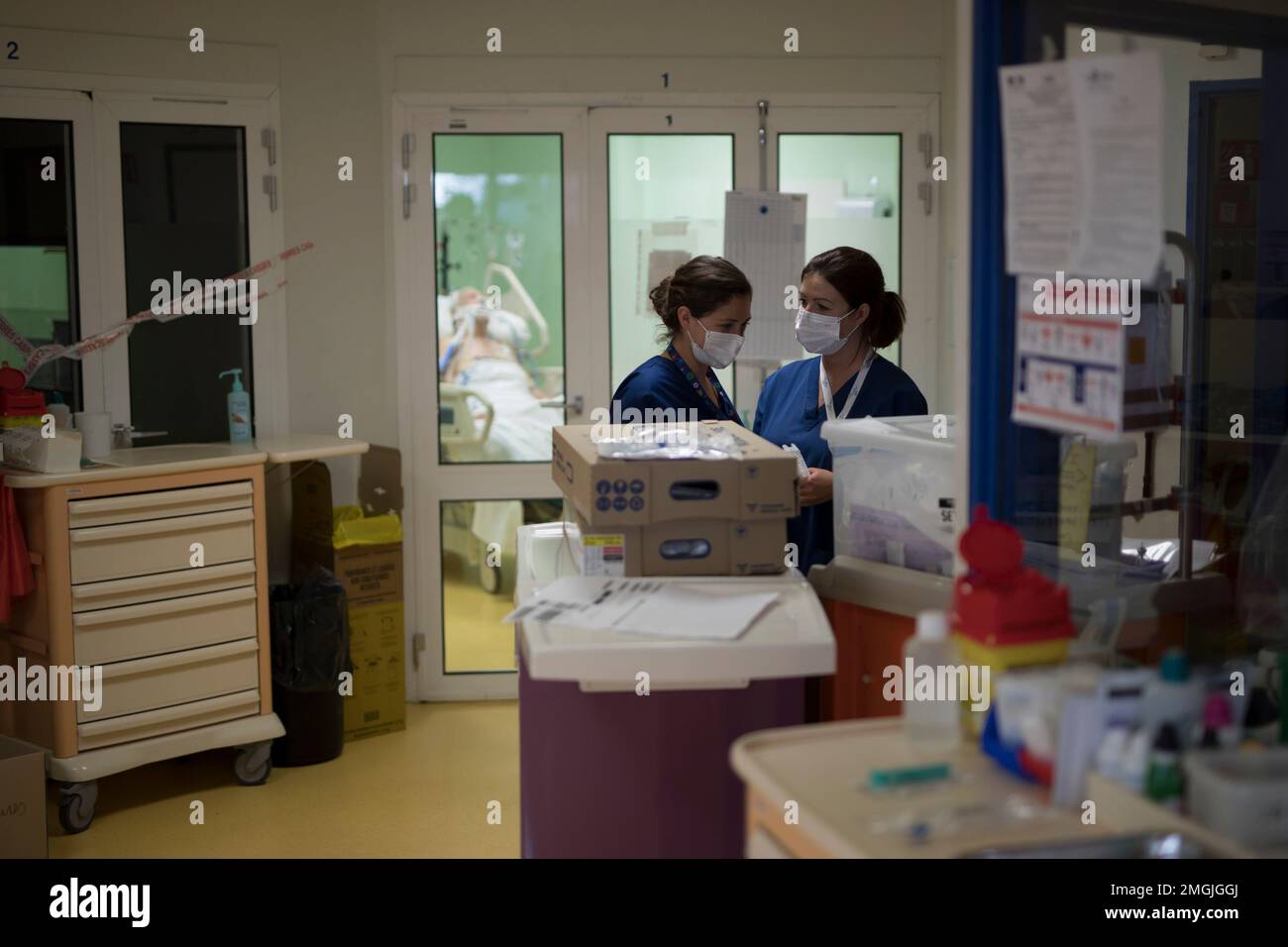Healthcare workers review papers and medications for COVID-19 patients ...