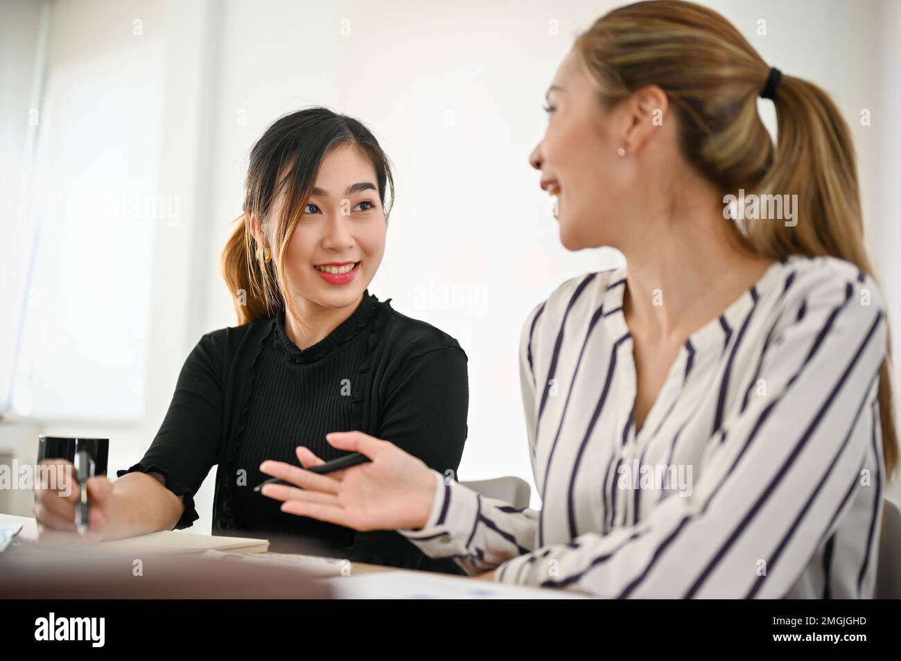 Happy and charming millennial Asian businesswoman or female marketing ...