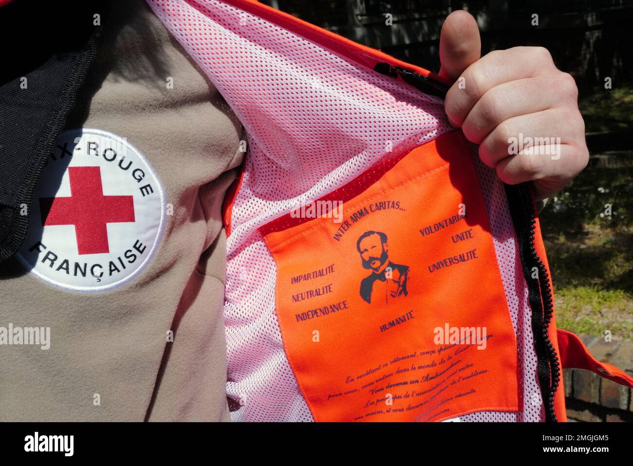 French Red Cross volunteer Martin displays the 7 Red Cross Fundamental ...