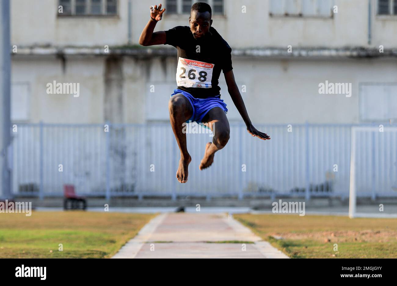 A Palestinian athlete competes in the long jump during the Central ...