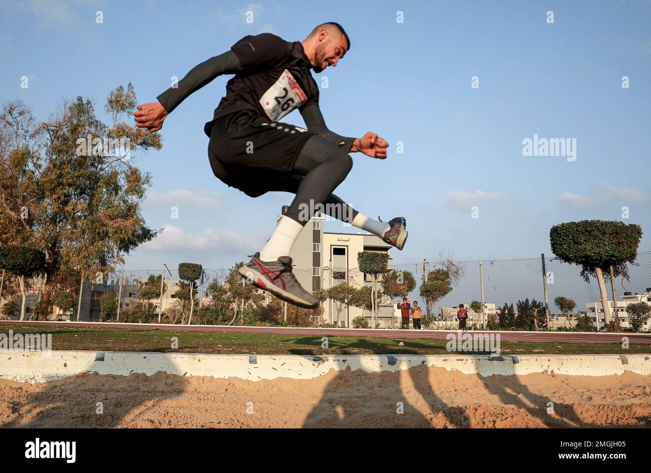 A Palestinian athlete competes in the long jump during the Central ...
