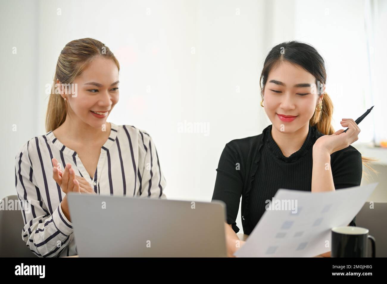 Happy and cheerful millennial Asian female boss applauding to her ...