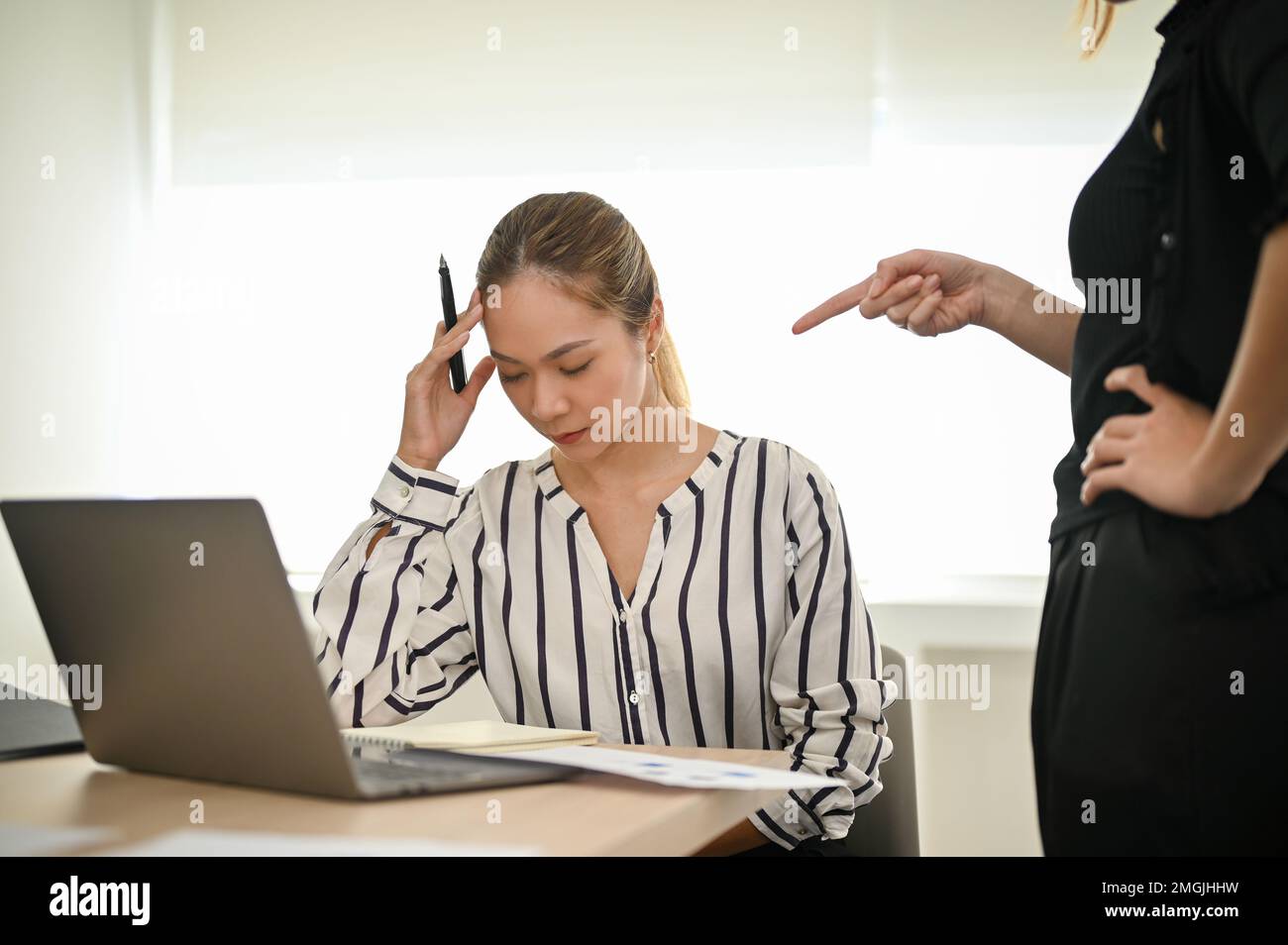 Stressed and frustrated young Asian female office worker or new ...