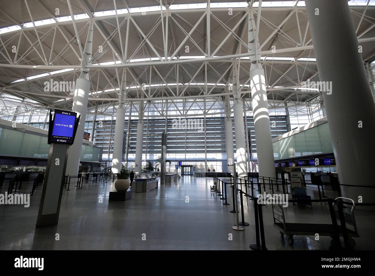 A nearly empty terminal is shown at San Francisco International Airport ...