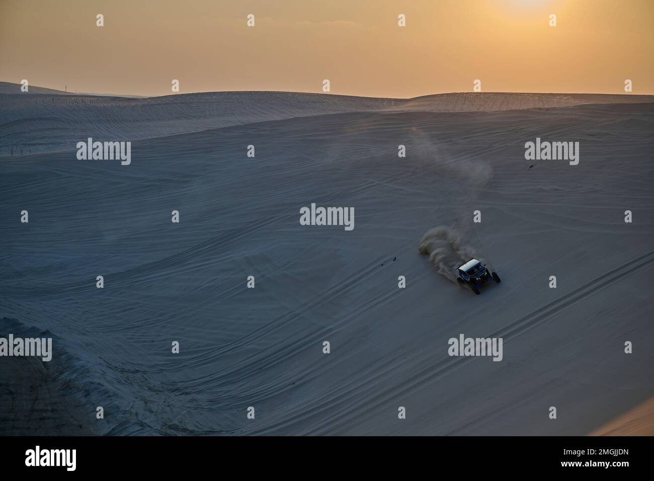 A 4x4 buggy racing over the dunes near Doha, where tourists and Qataris ...