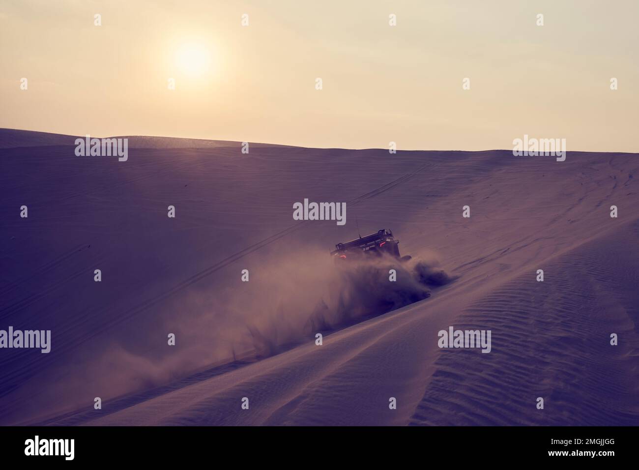 A 4x4 buggy racing over the dunes near Doha, where tourists and Qataris ...