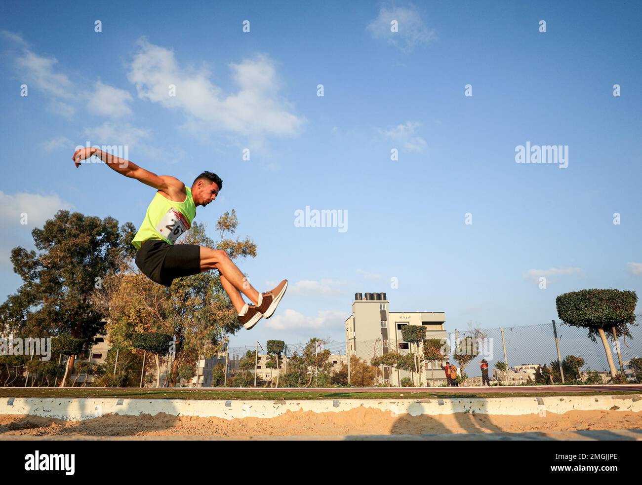 A Palestinian athlete competes in the long jump during the Central ...