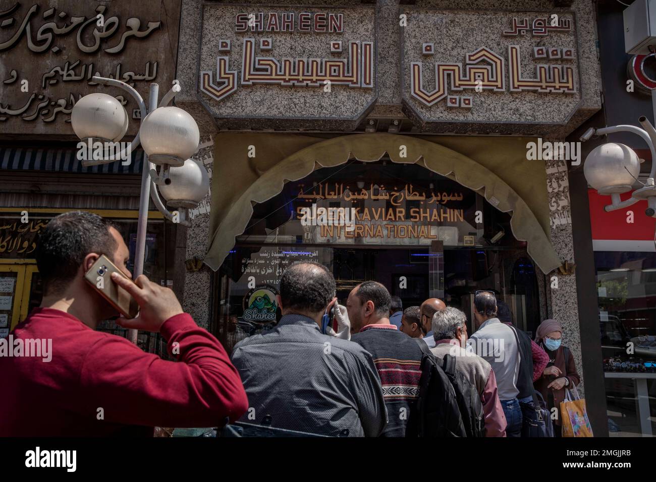 People wait in line to order fish to make fesikh, a traditional dish ...