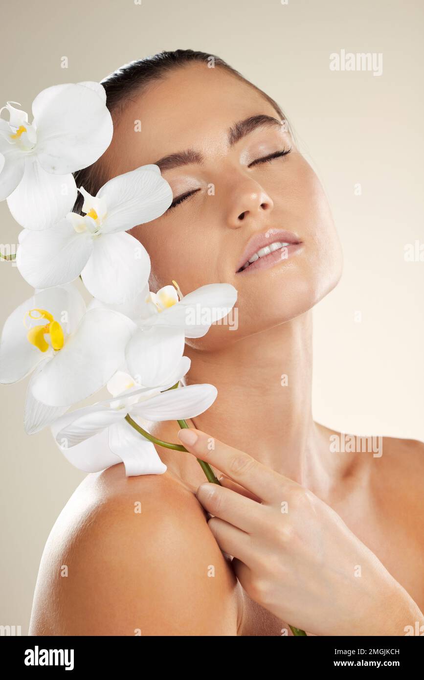 Skincare, beauty and woman with orchid flower on skin for natural ...
