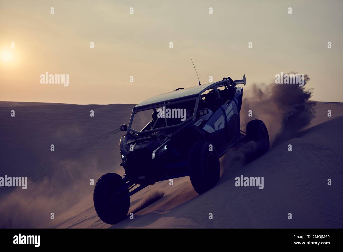 A 4x4 buggy racing over the dunes near Doha, where tourists and Qataris ...
