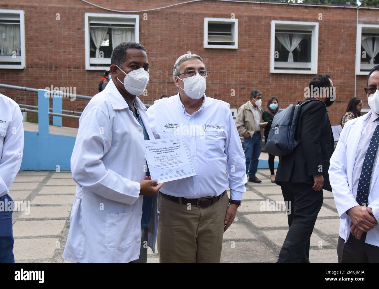 Dr. Miguel Coello, left, a local national officer with the Health ...