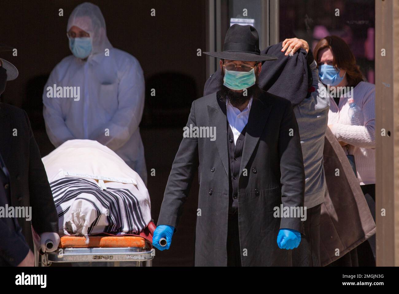 Family members and members of Hevra Kadisha, an organization which ...