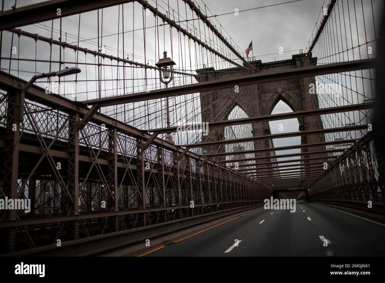 A lone car travels along the Brooklyn Bridge towards Manhattan in New ...