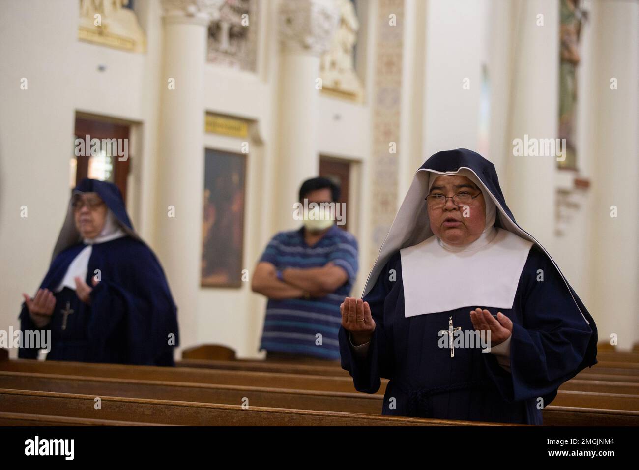Nuns with the Sisters of Bethany Order pray during a closed Easter Mass ...