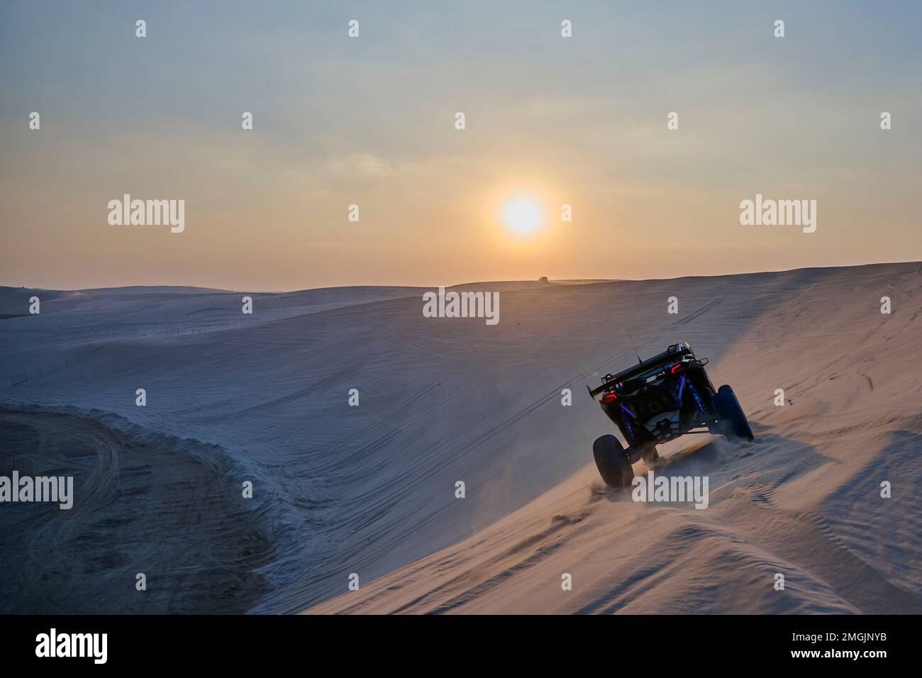 A 4x4 buggy racing over the dunes near Doha, where tourists and Qataris ...