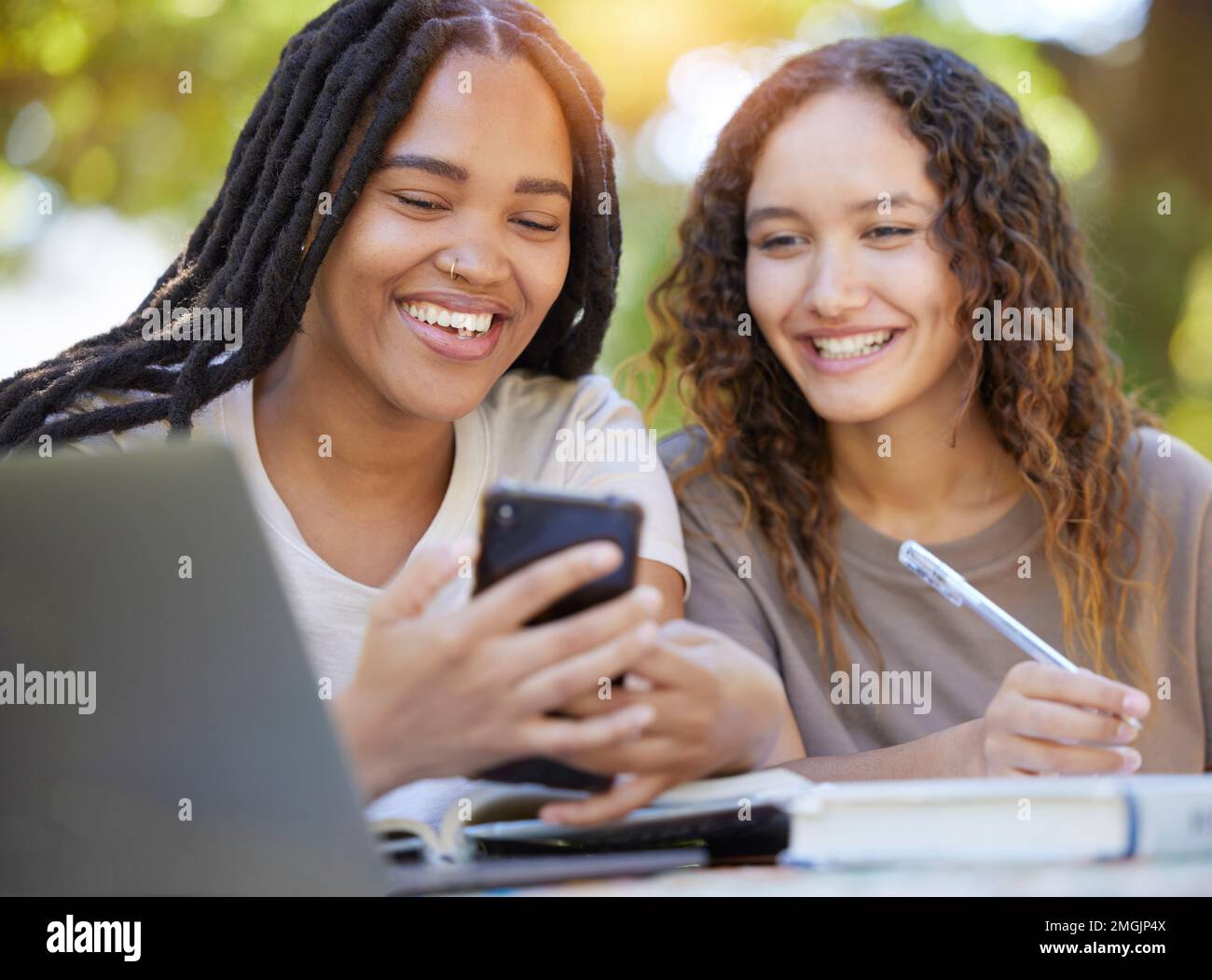 Students, women and friends with phone at park laughing at funny meme ...