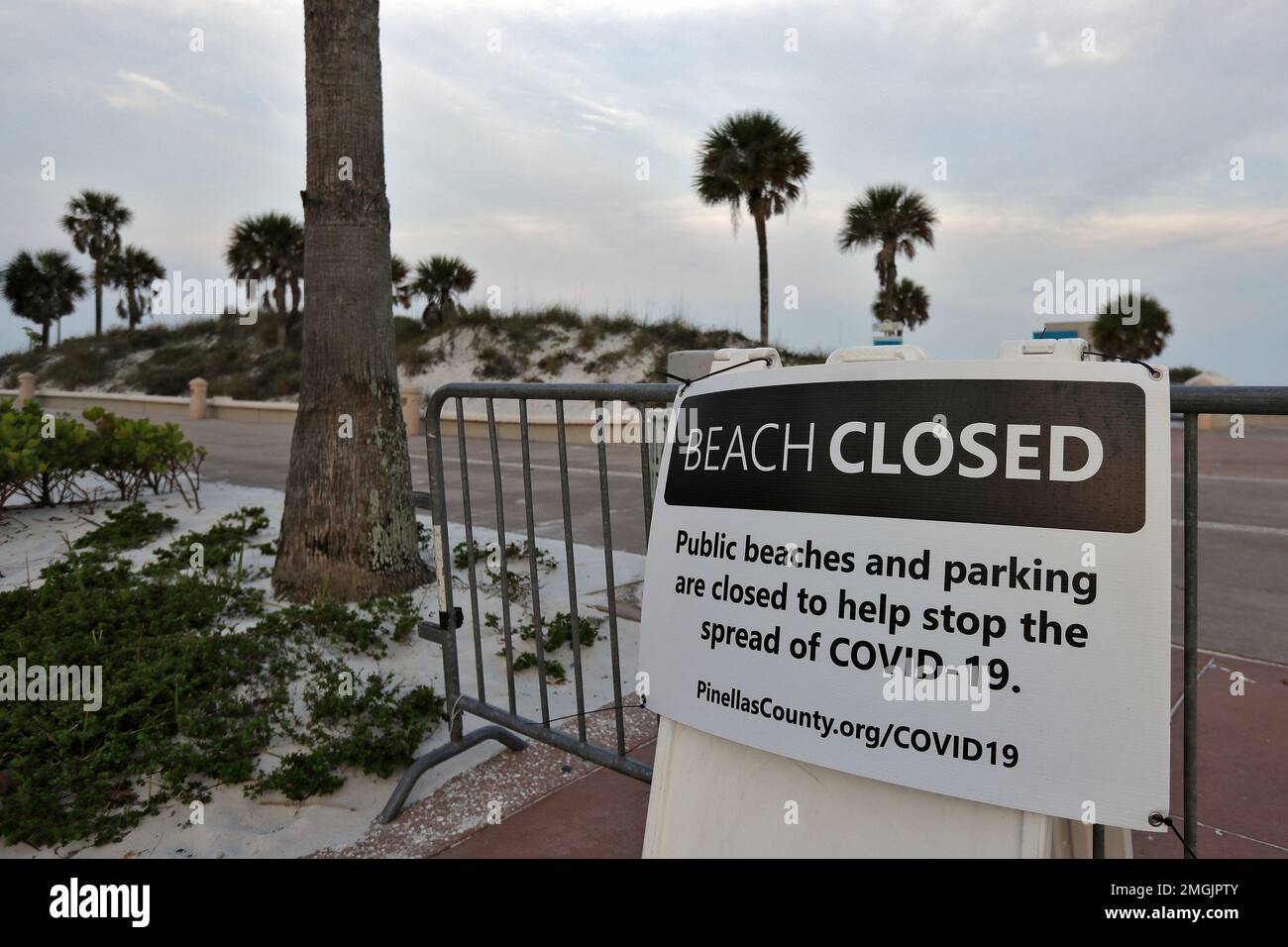 A sign is posted on Clearwater Beach at sunrise on Easter Sunday, April ...