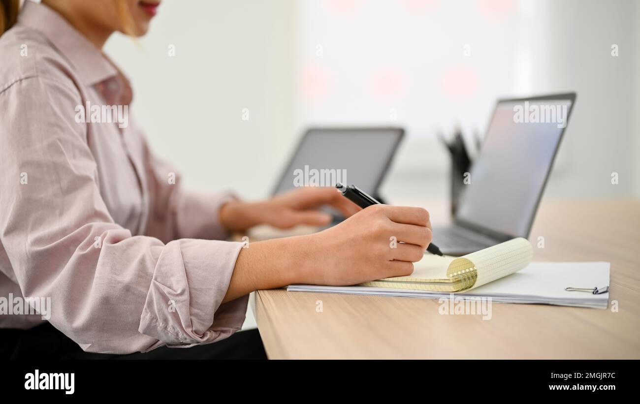 cropped shot, Attractive millennial Asian businesswoman working at her ...