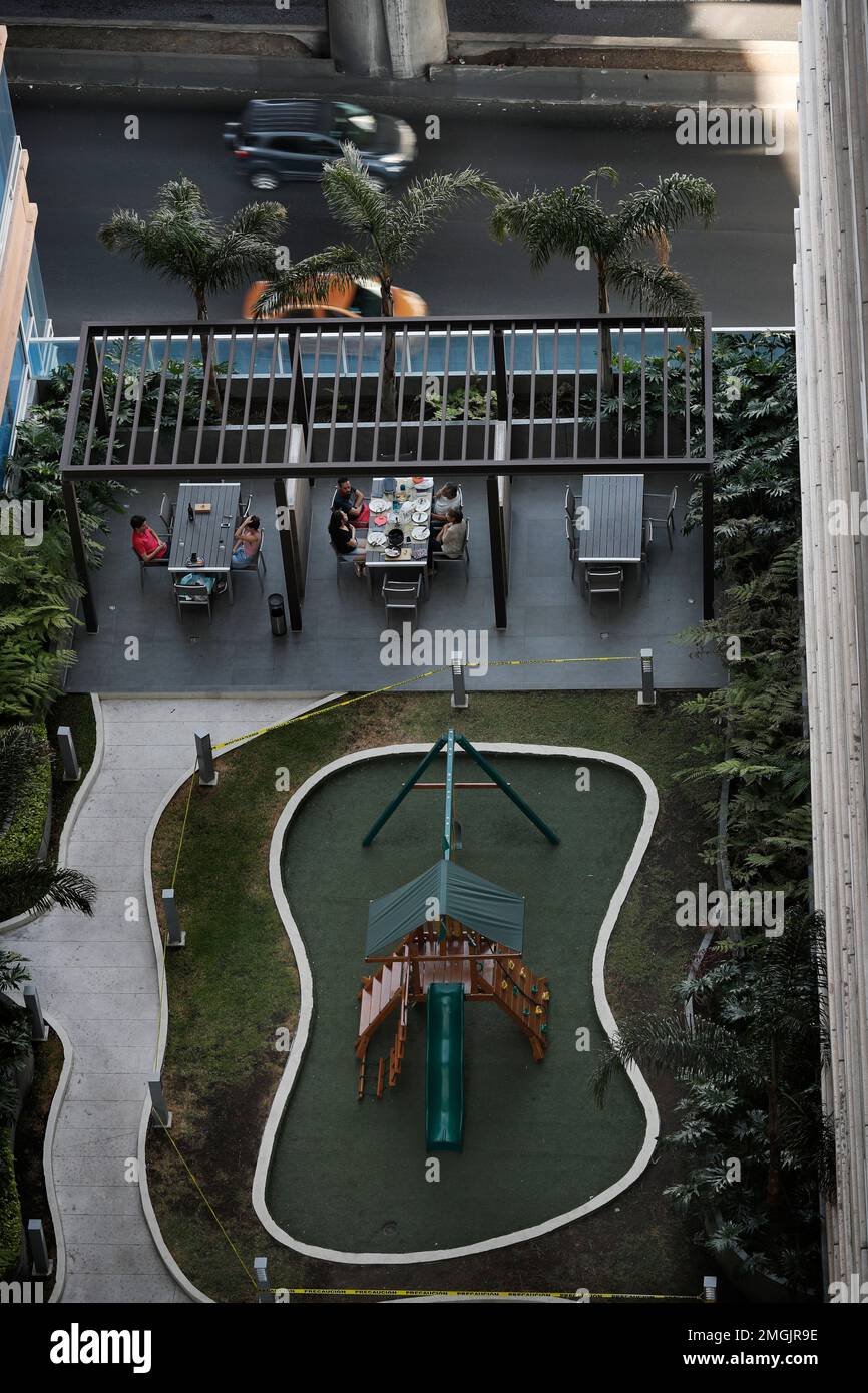 A family shares a meal on the terrace of a building during the COVID-19 ...