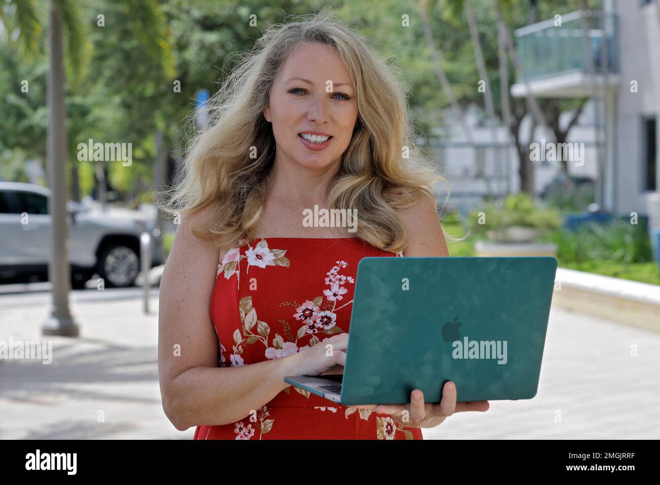Tonya Olson poses for a photo outside her apartment building Saturday ...