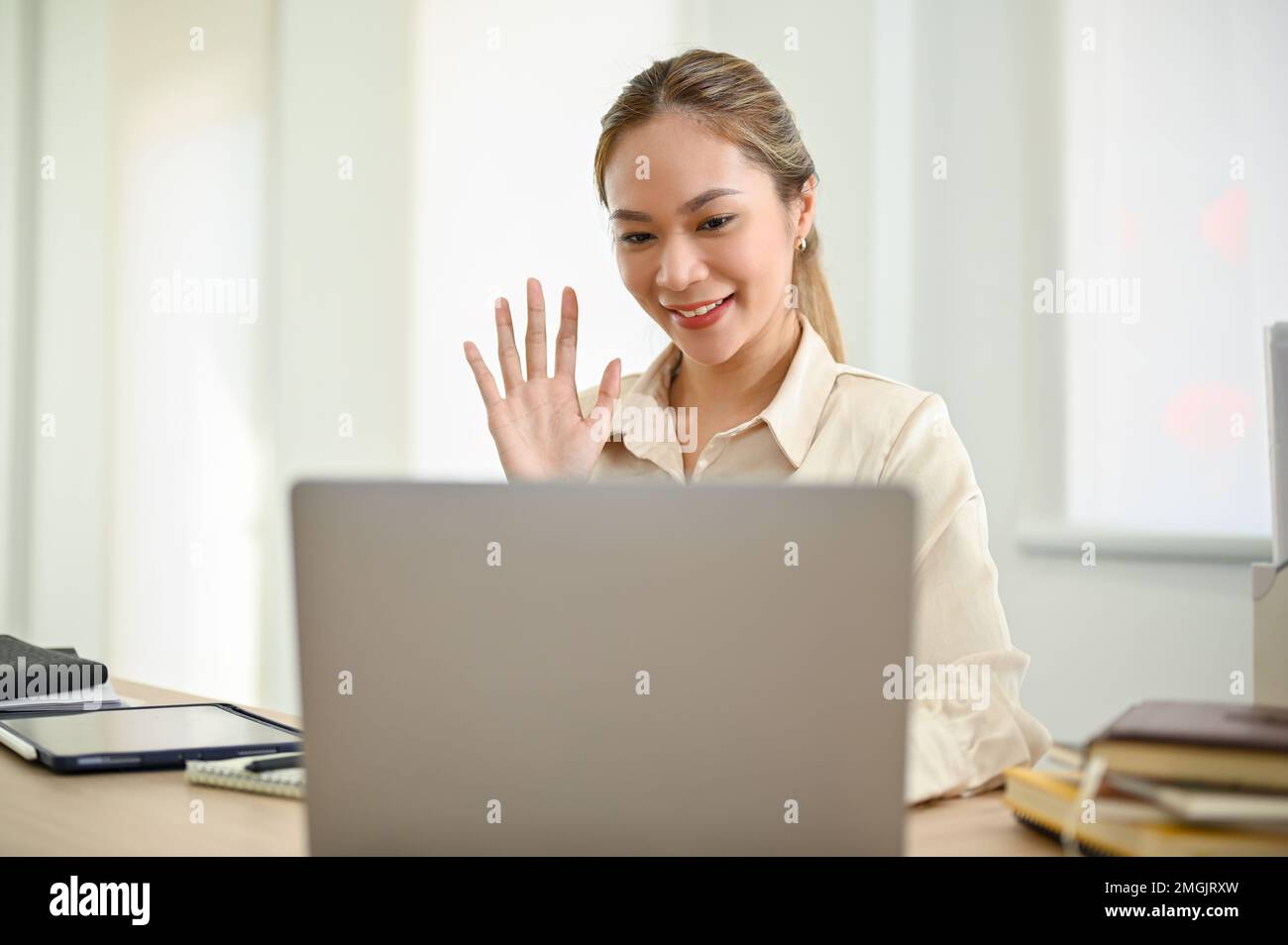 Charming and happy millennial Asian businesswoman or female manager ...