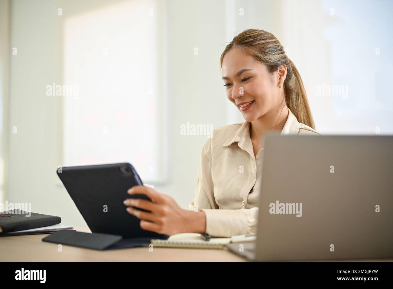 Attractive millennial Asian businesswoman or female boss looking at ...