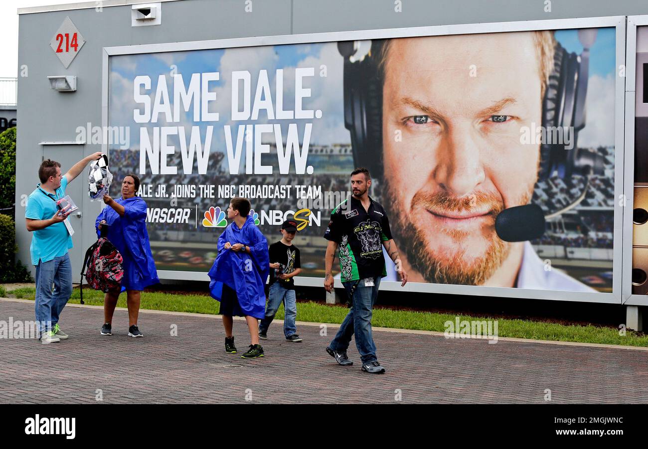 FILE - In this July 6, 2018, file photo, auto racing fans walk by a ...