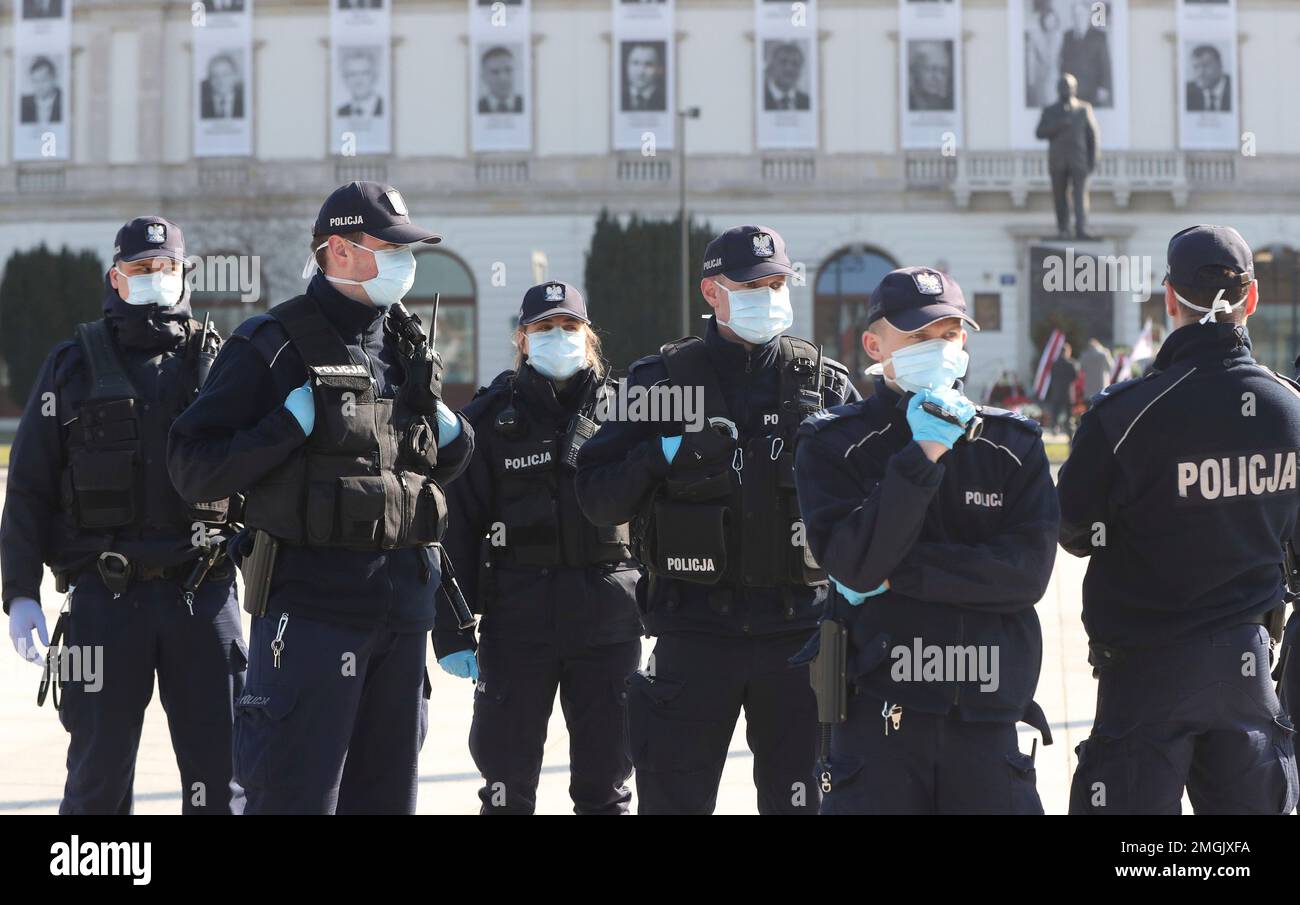 Police in masks against the coronavirus spread watches over a scaled ...