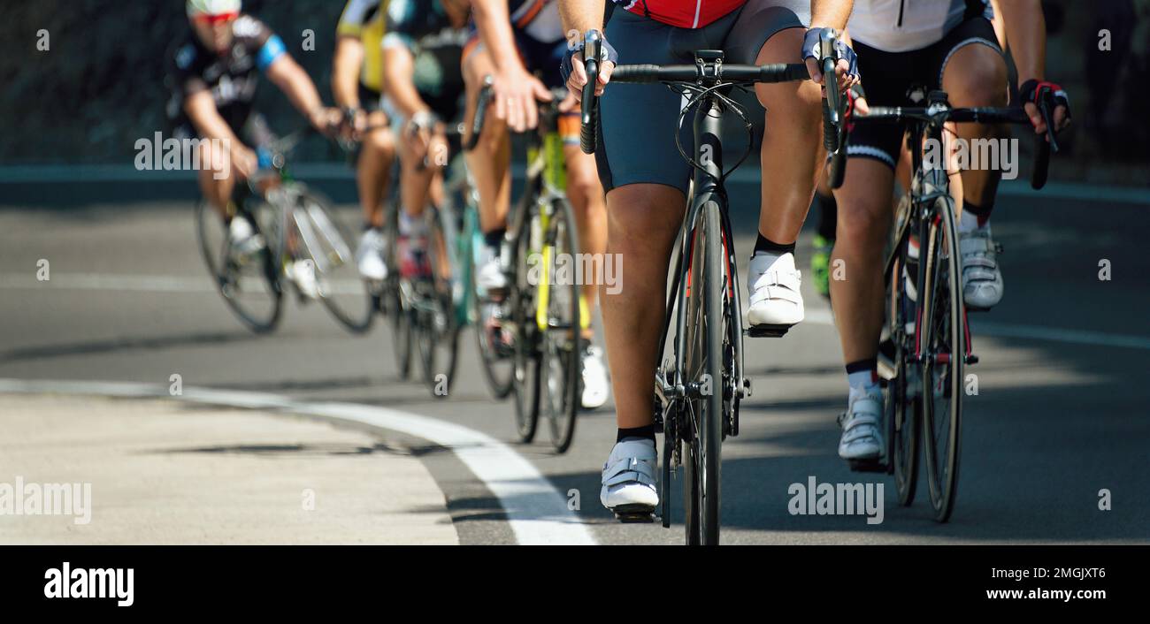 Cyclists with racing bikes during the cycling road race, when climbing ...