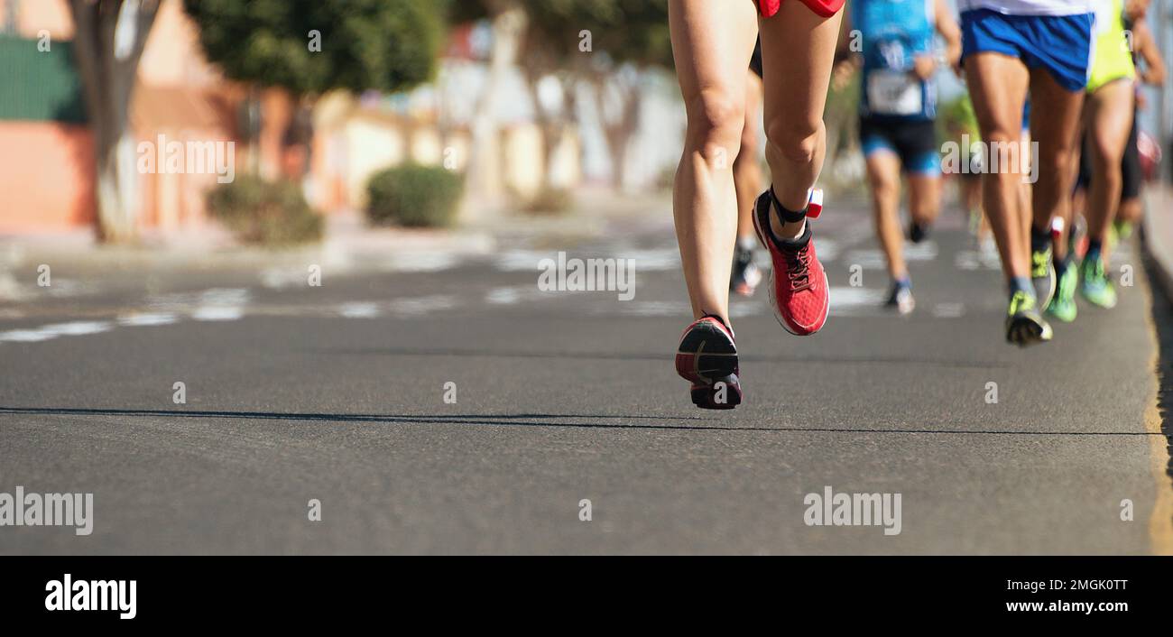 Marathon running in the light of evening,running on city road detail on ...