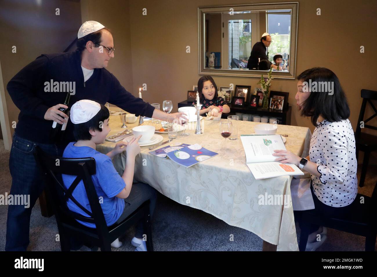 Seth Pollack pours wine for his family, wife Jessica Choe and children ...