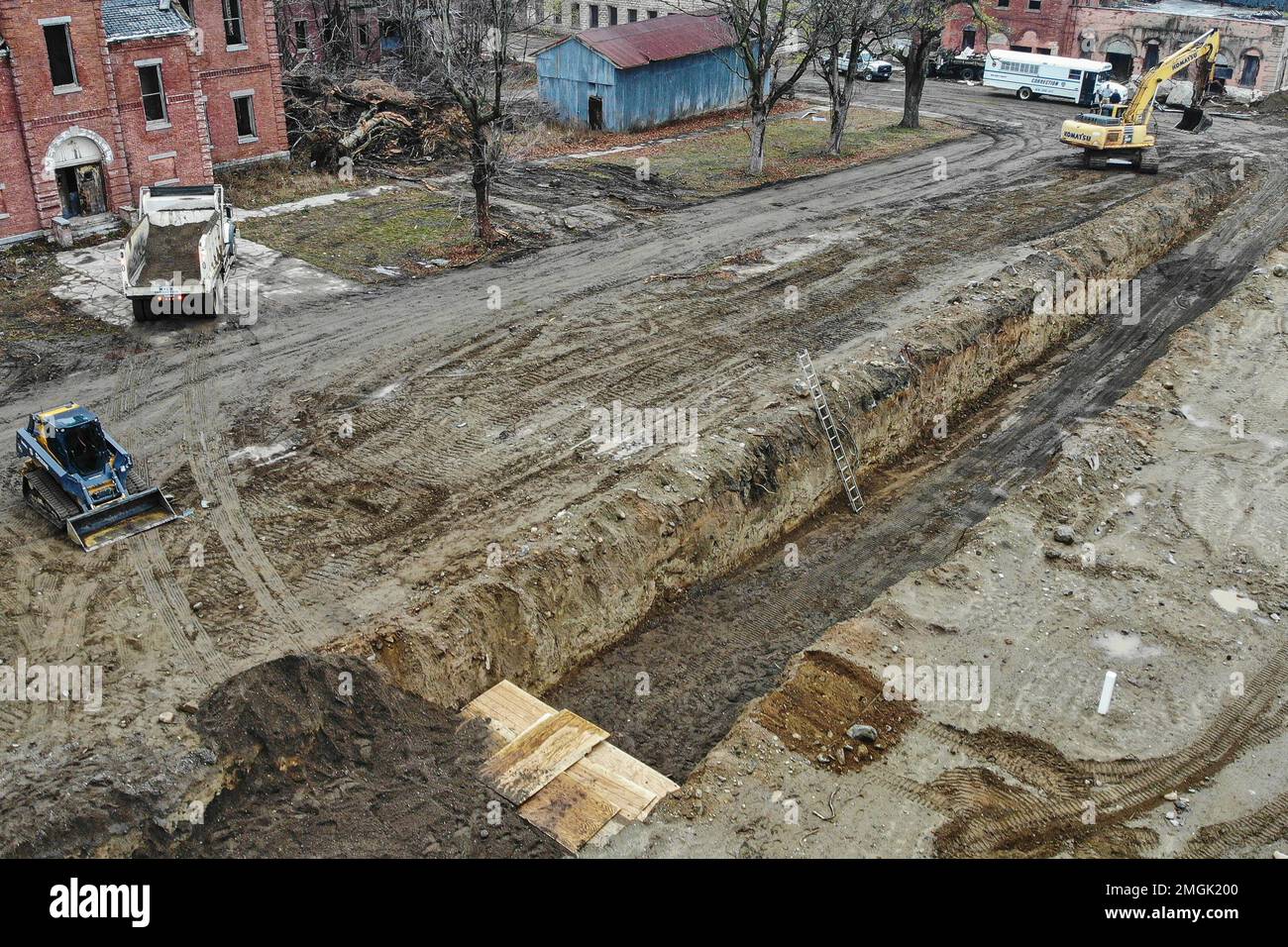 Bodies are buried in a trench on Hart Island, Wednesday, April 8, 2020, in the Bronx borough of ...