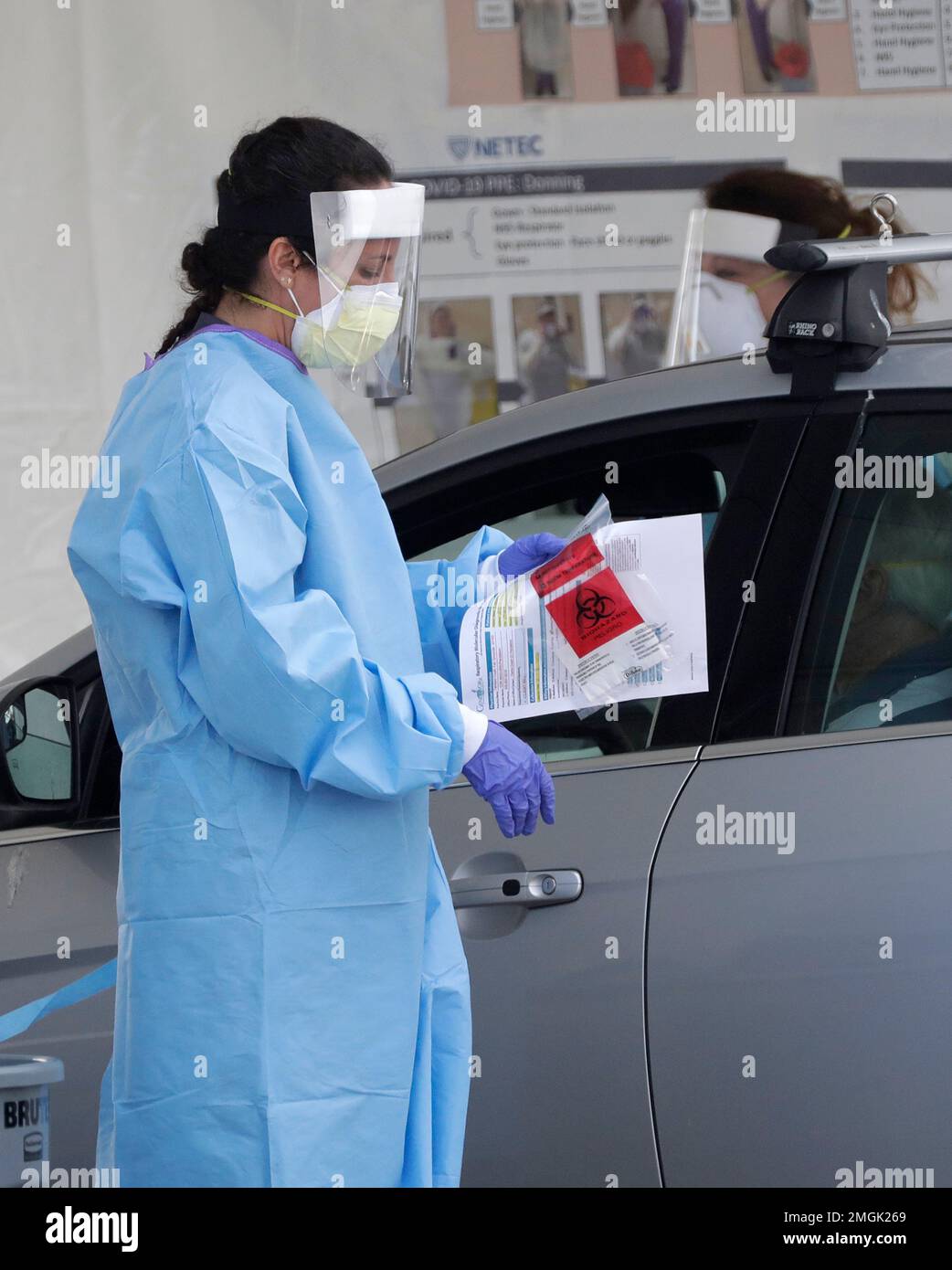 A healthcare worker prepares material to test a driver at a newly ...