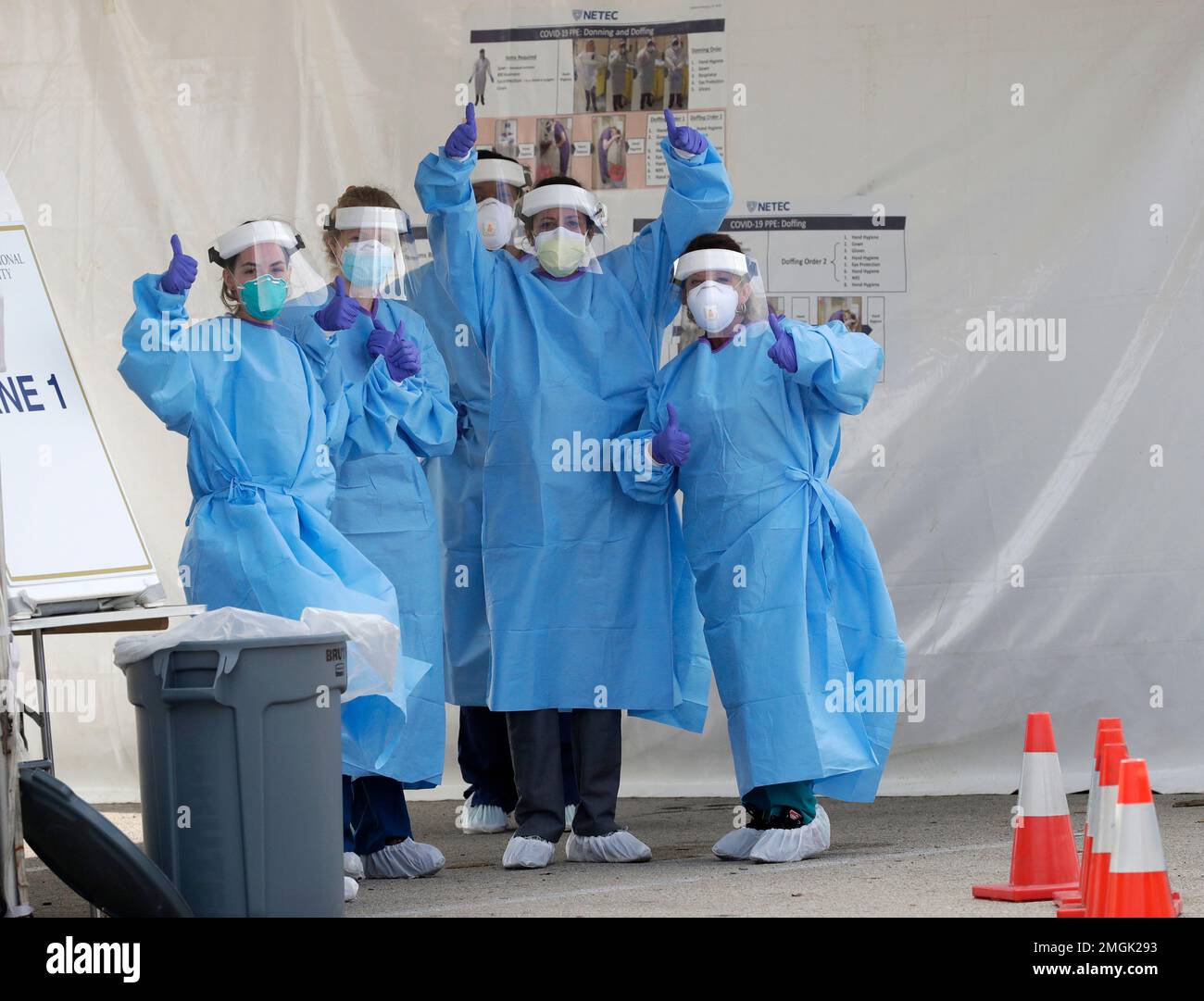 Healthcare workers give a thumbs up for the cameras at a newly opened ...