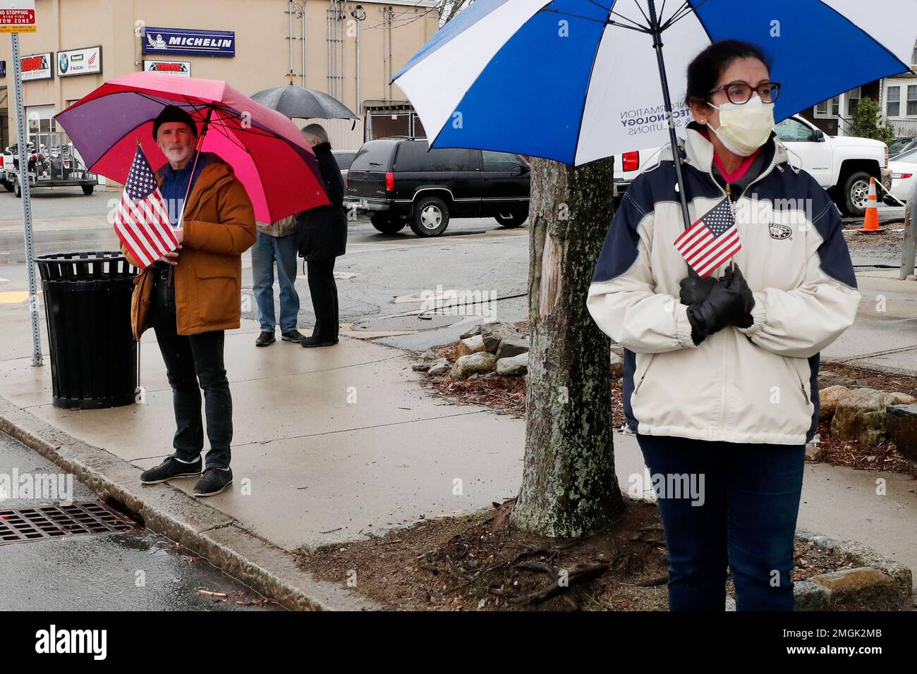 Mourners stand along a processional route for veteran Mary Foley ...