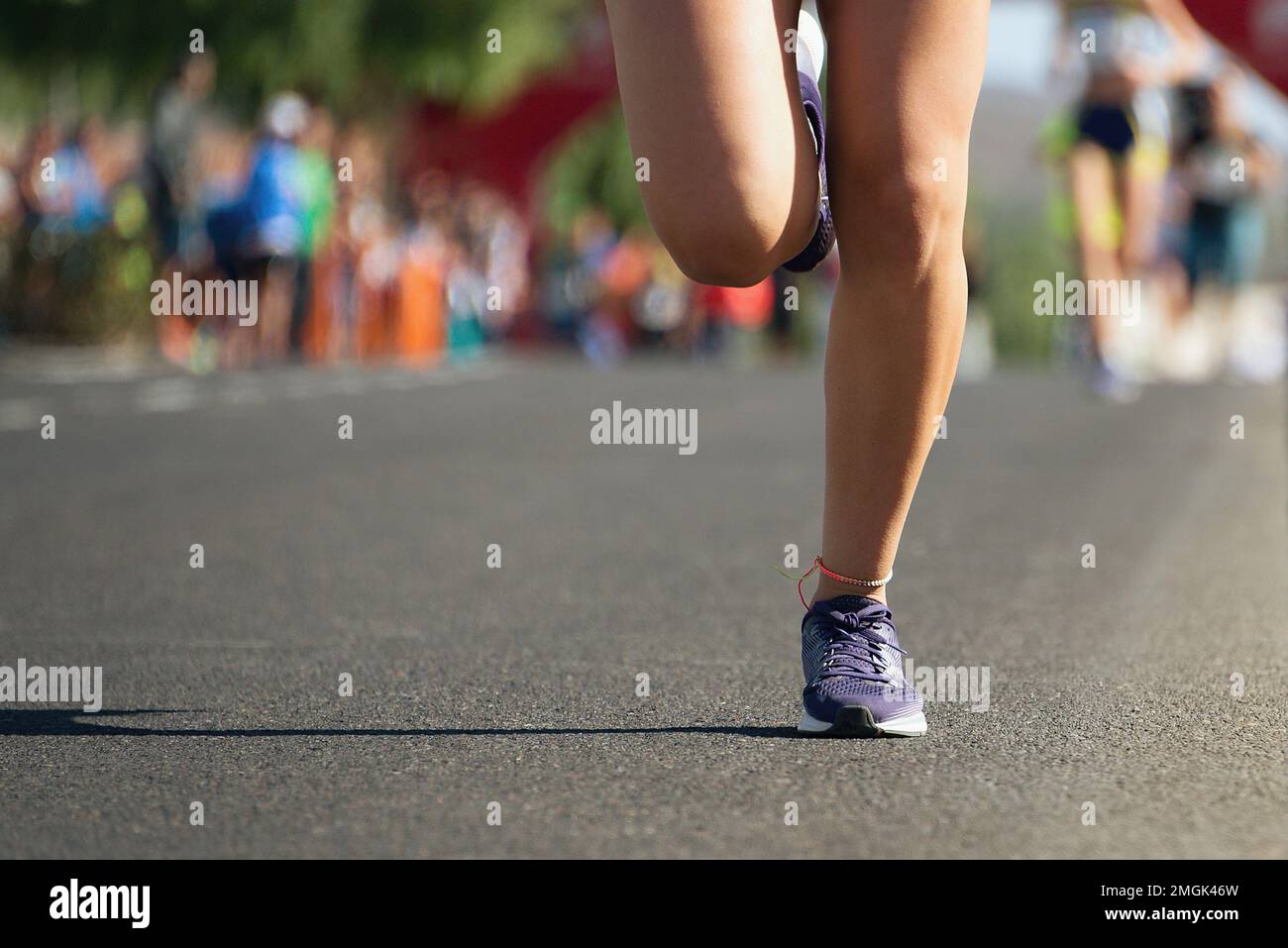 Marathon runners running on city road,detail on legs Stock Photo - Alamy