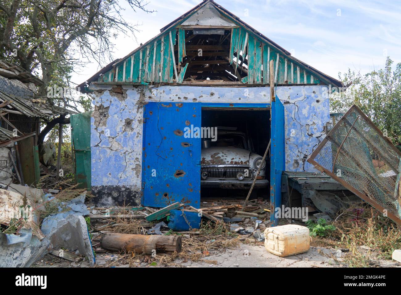 Destroyed civilian car is in the garage. On the body of the car there ...