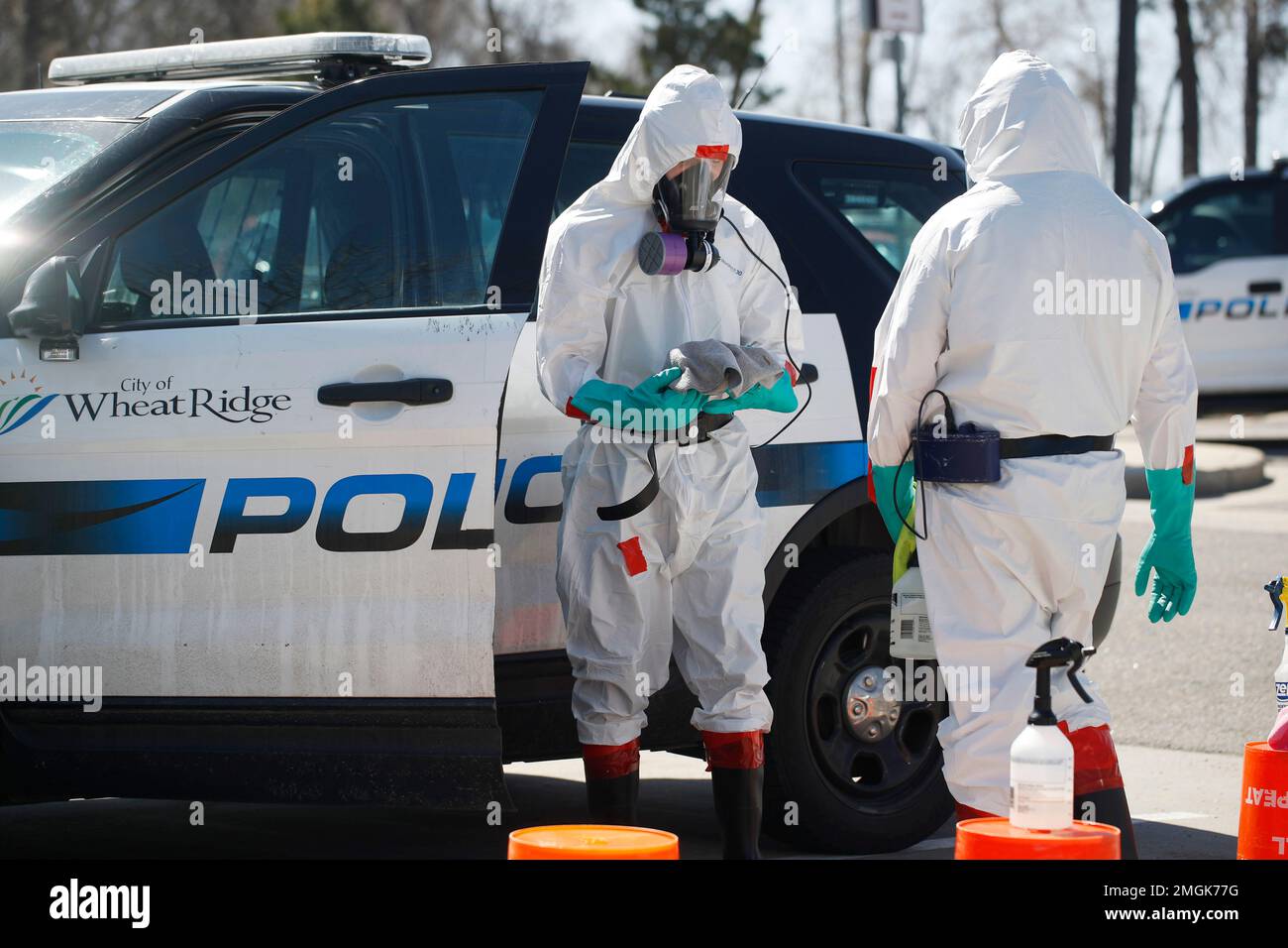 Workers from a biohazard company, wearing personal protective equipment ...
