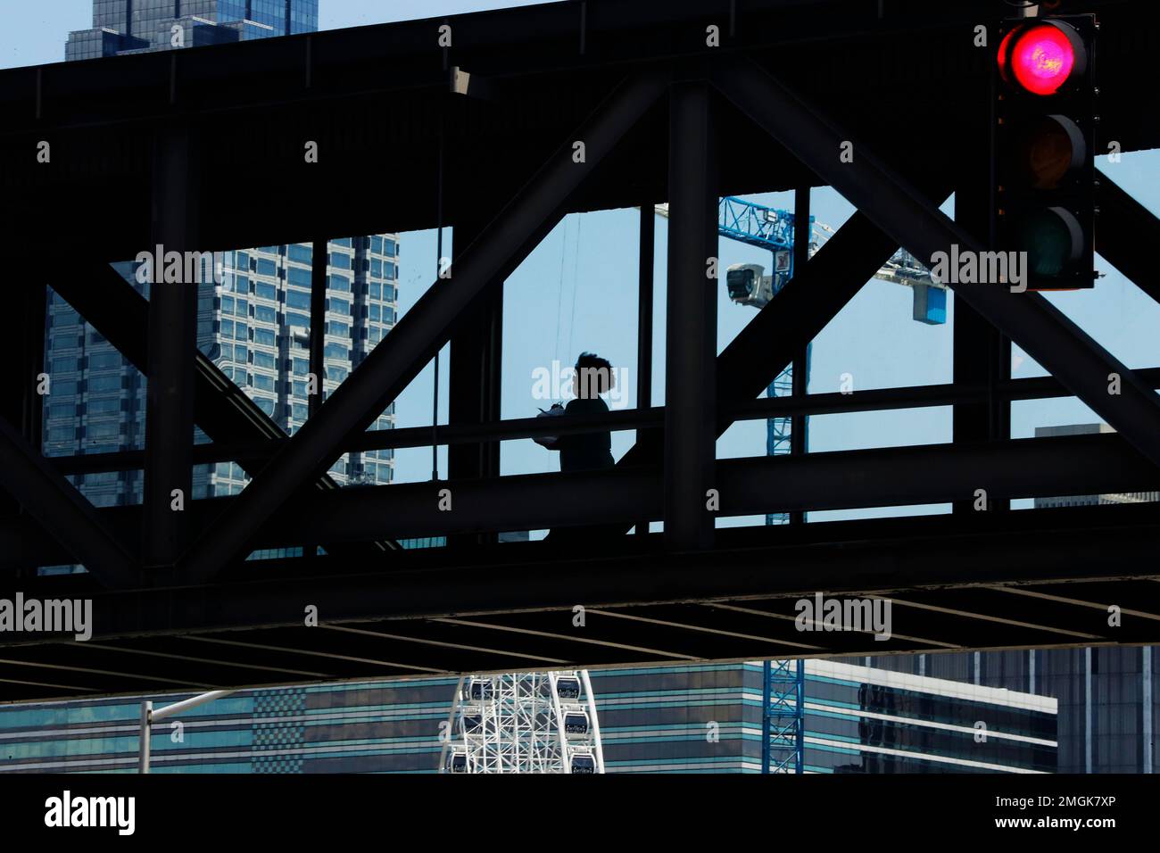 A person walks over a bridge in downtown Atlanta Monday, April 6, 2020 ...