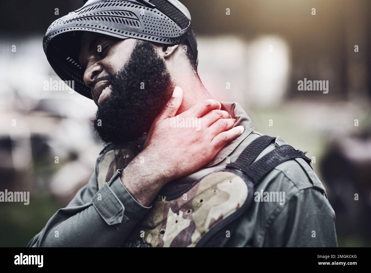 Man, neck pain and paintball injury holding sore area, joint or ...